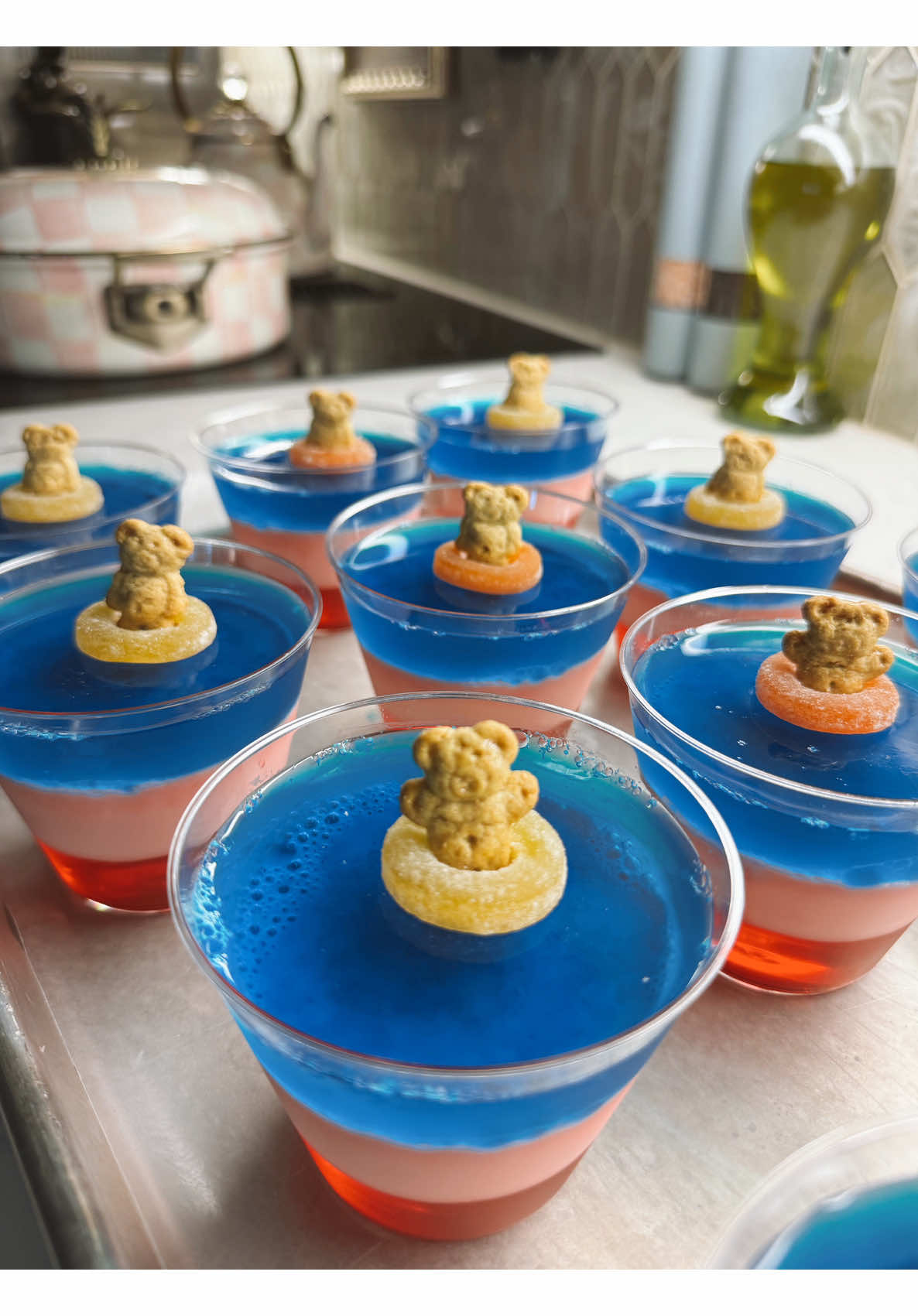 Summery layered jelly dessert cups in red, pink, and blue with cute ...