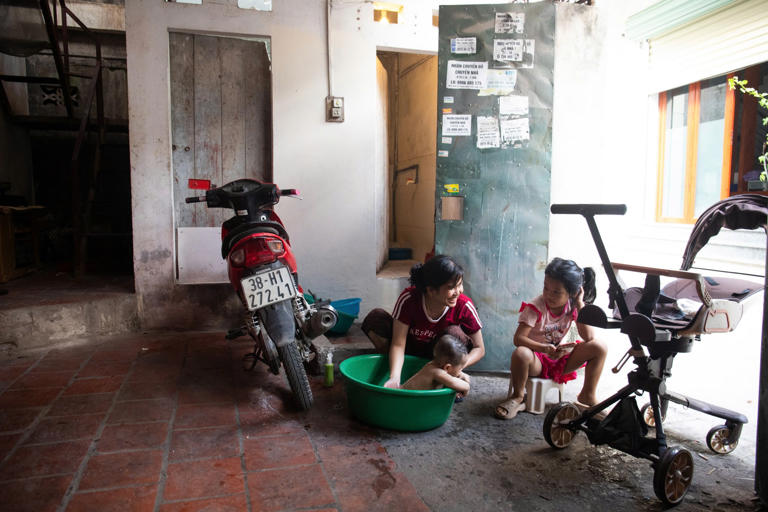 Hanoi factory workers endure 40°C heat in cramped rental rooms without ...