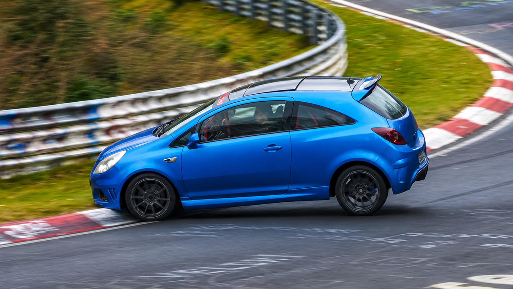 Opel hatchback nearly flips over mid-corner after losing control