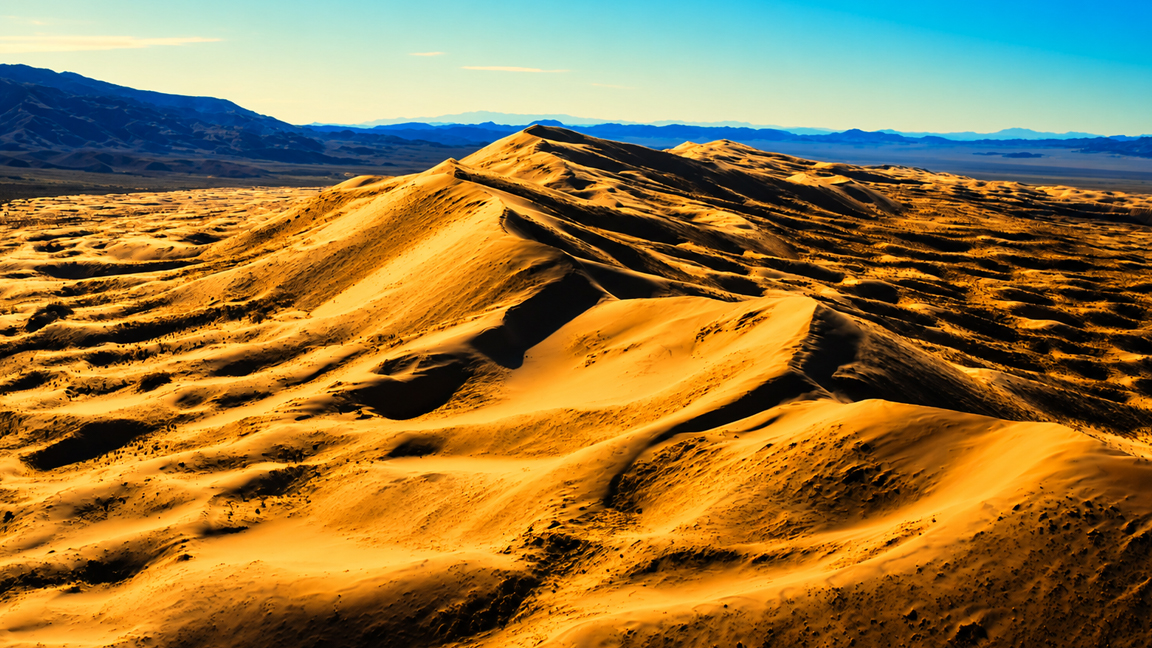 A desert landscape shaped like frozen ocean waves