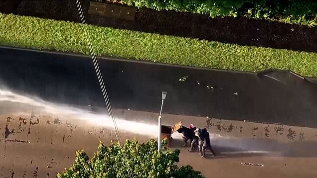 Police in Northern Ireland use water cannons to push back protesters