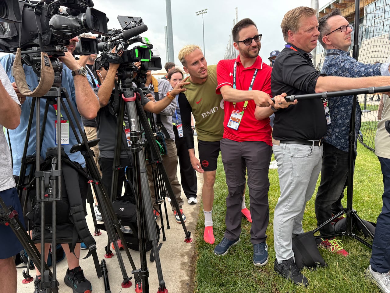 Liam Millar sneaks in while his teammate speaks to reporters
