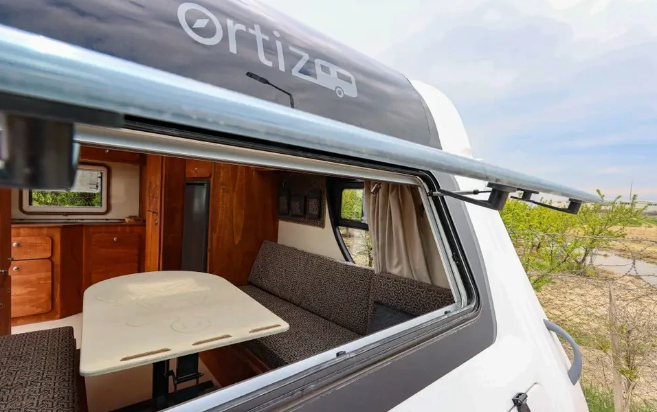 Mini House camper expands from compact tow to roomy cabin