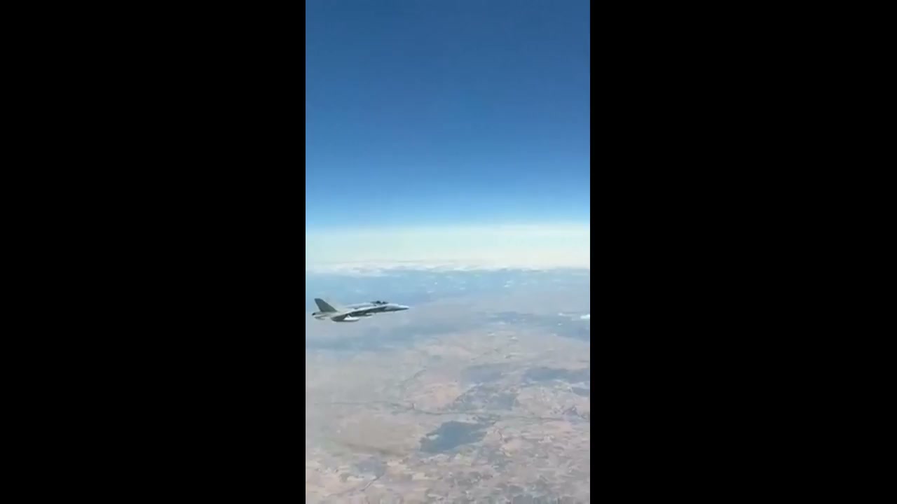 Pope Leo waves to fighter jet escorts from cockpit of Barcelona flight