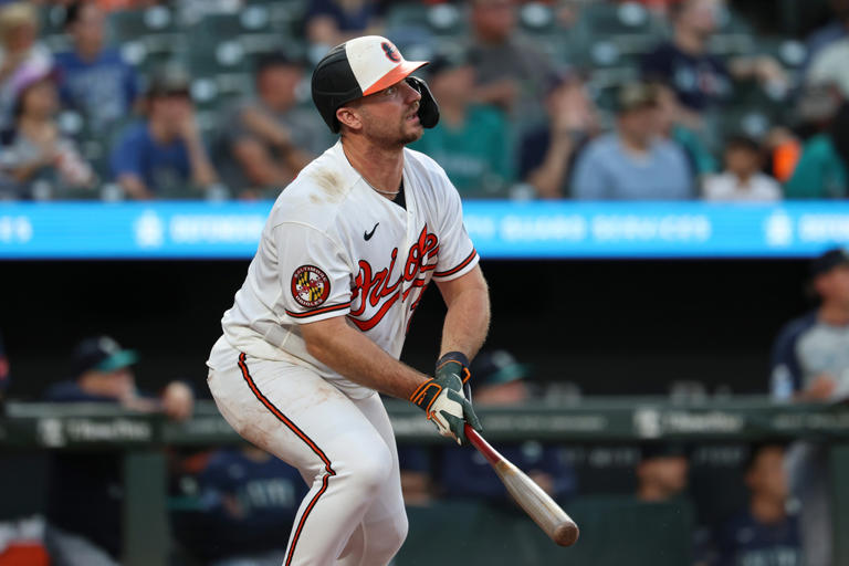 Holliday hits grand slam and Young pitches Orioles past Mariners 7-2 to ...