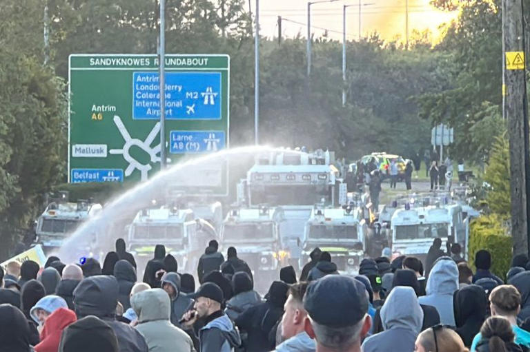 Protestor sets himself alight with petrol bomb as clashes with police ...
