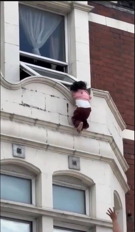 Heroic bystander and police save toddler dangling from window ledge in ...