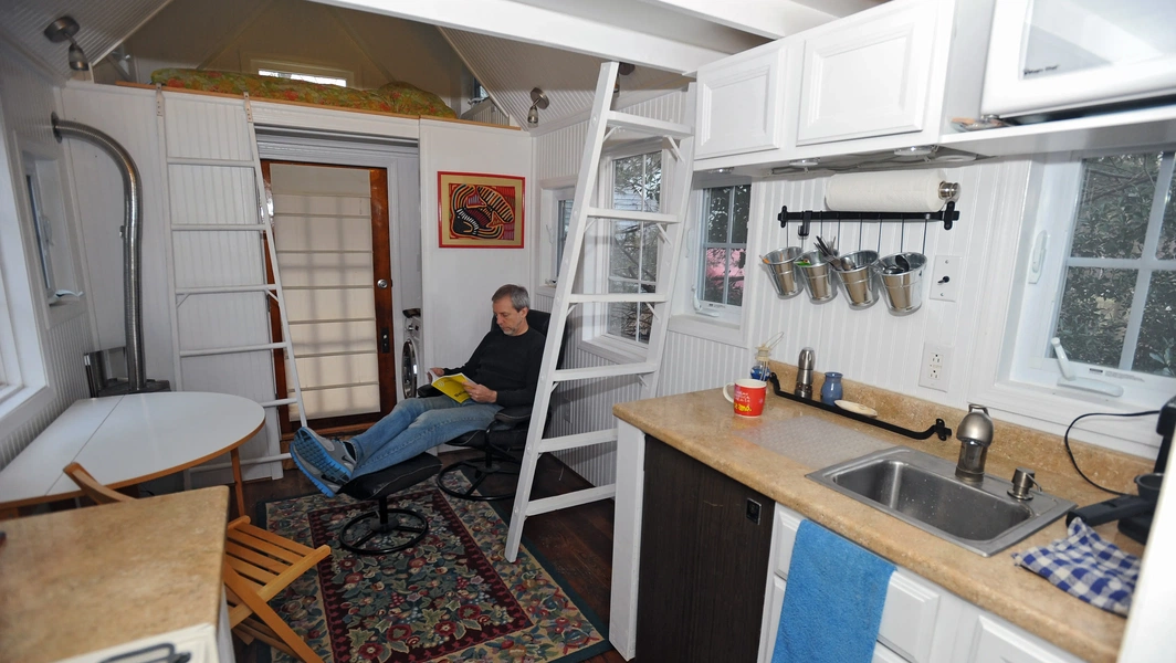 Mini House camper expands from compact tow to roomy cabin