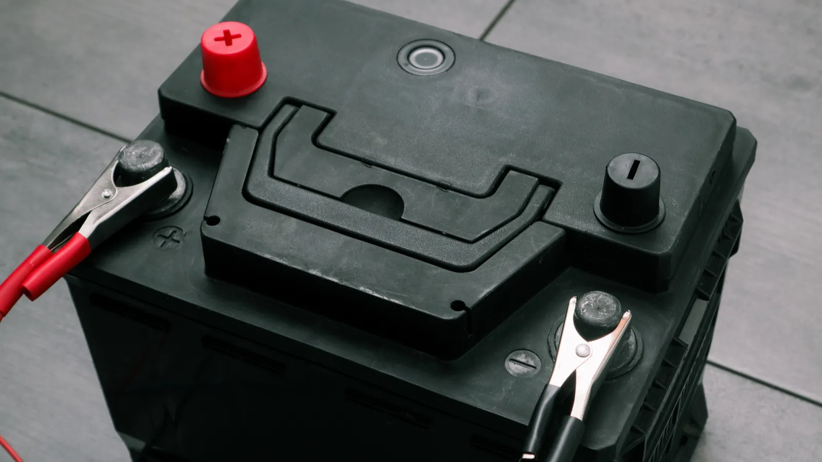 Changing a car battery starts with the negative terminal, not the red one