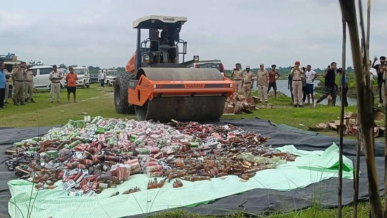 Majuli police use road rollers to crush bottles of illegal liquor ...