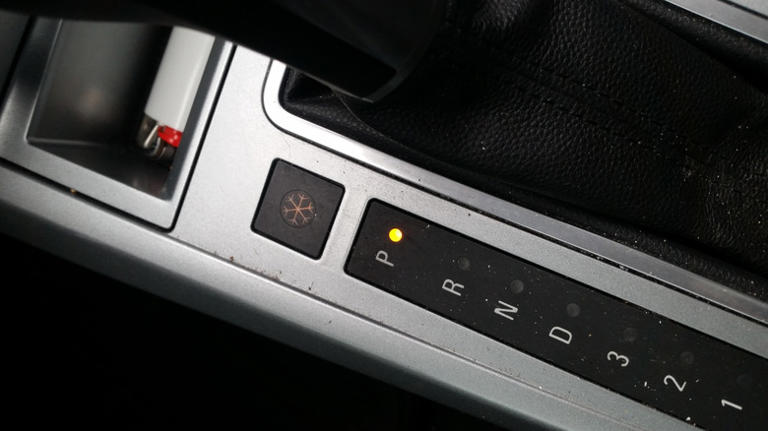 If your car has a snowflake button near the gear shift, here's what it does