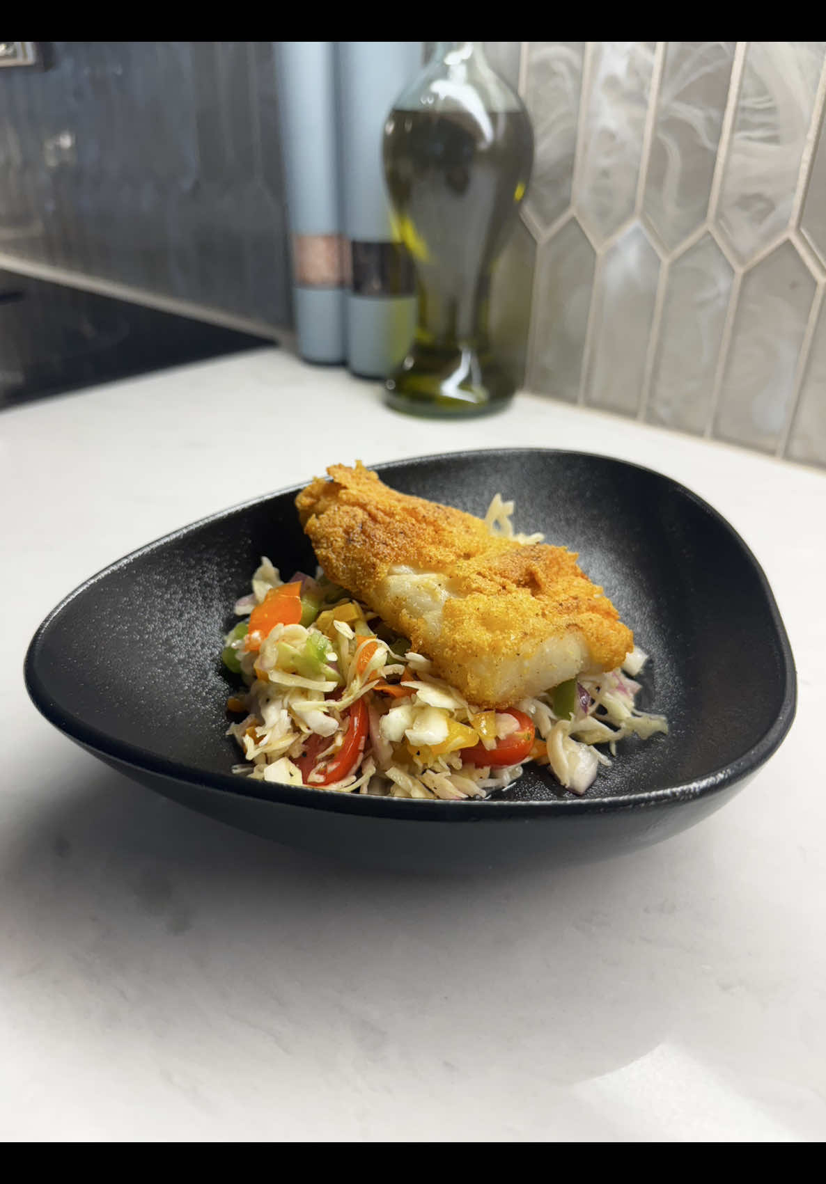 A golden fried fish fillet with a crunchy cabbage and bell pepper slaw ...