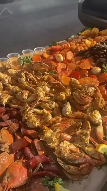 Giant seafood boil table loaded with crab shrimp and corn