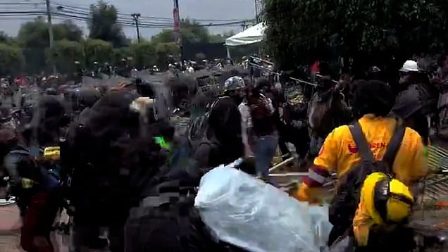 Riot police clash with protesters hurling stones outside World Cup ...