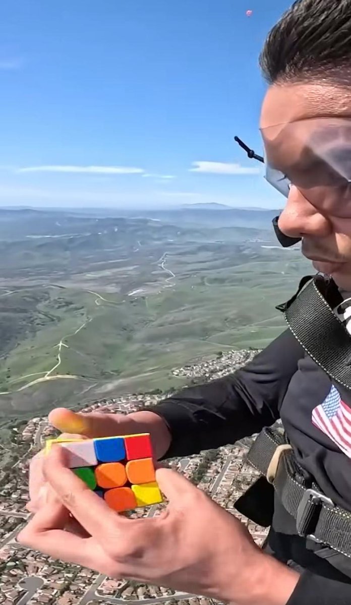 Watch: Man solves two Rubik's cubes while skydiving to break world record