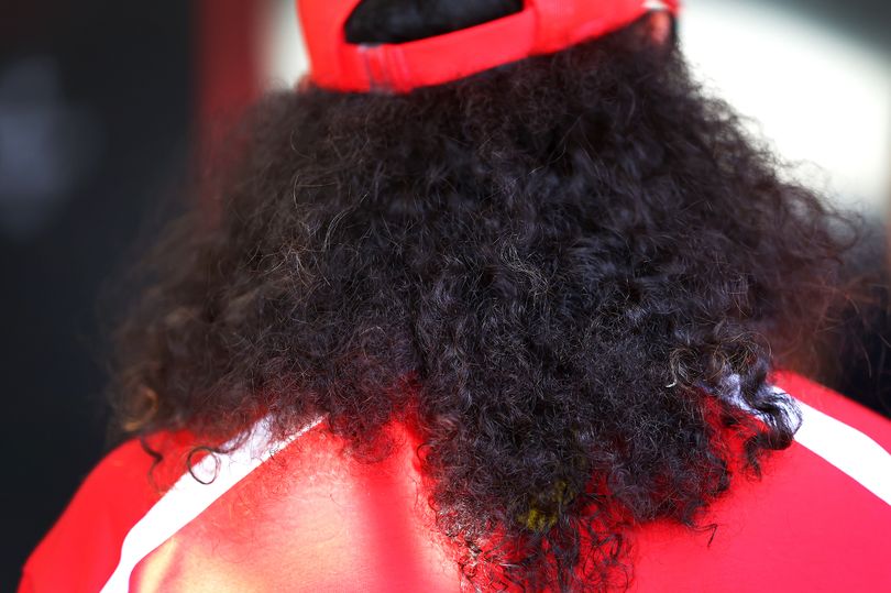 Lewis Hamilton lets it all hang out as he shows off his lush long locks ...