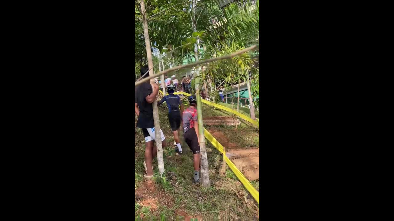 Mountain biker flips head over handlebars on downhill course