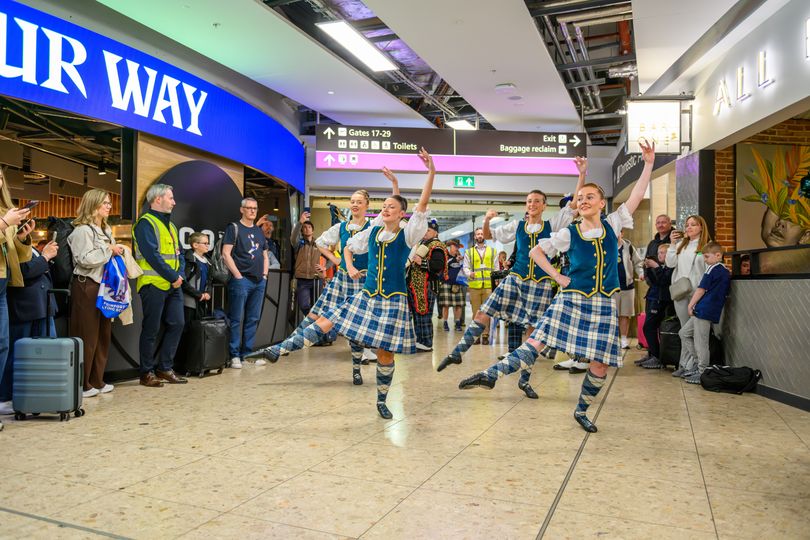 Edinburgh football fans escorted through airport with pipes and drums