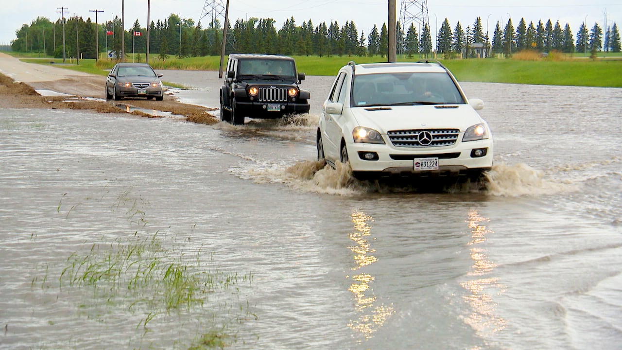 Highway cut, fields flooded in rural municipality of Rosser