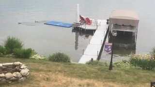 Dog jumps off dock chasing ducks