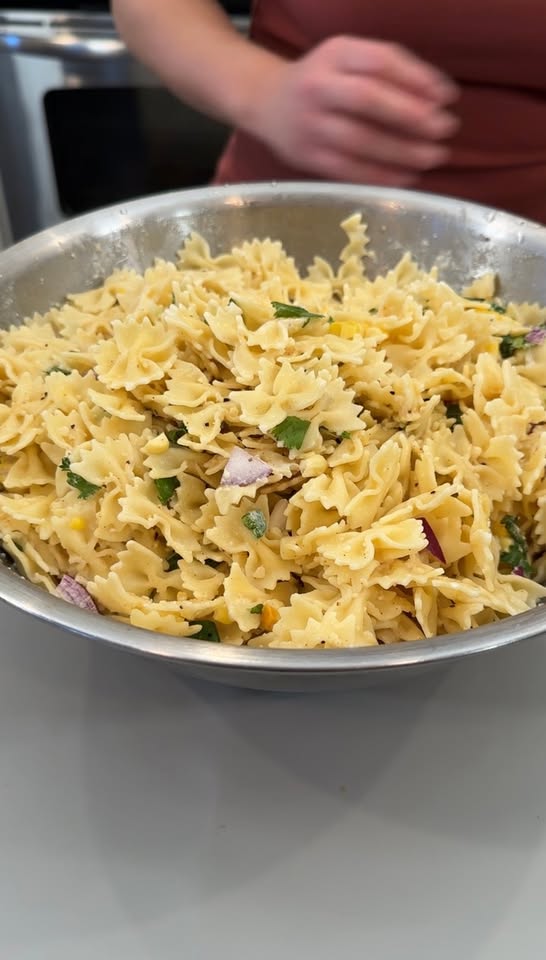 Spring pasta salad packed with corn, lime, and fresh herbs