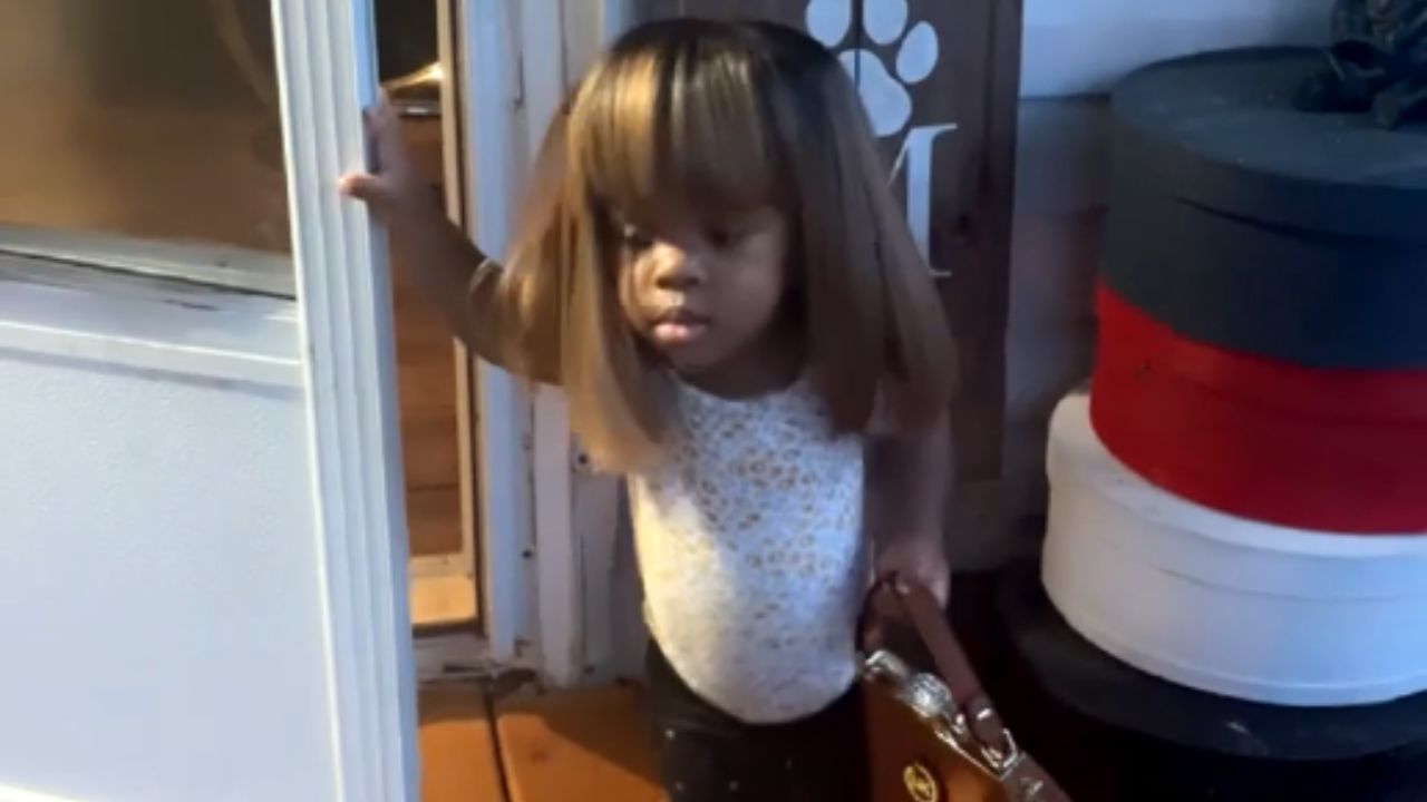 Charming young child flaunts impressive fashion sense with wig and ...