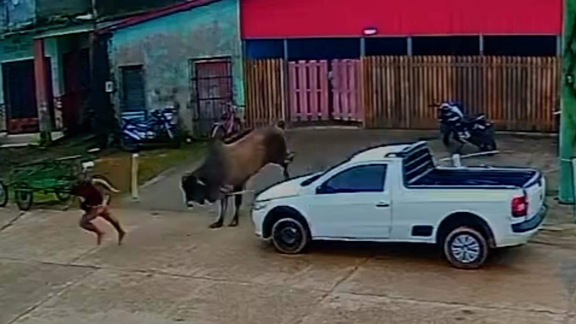 Rampaging bull knocks over motorbike and charges after man after he ...