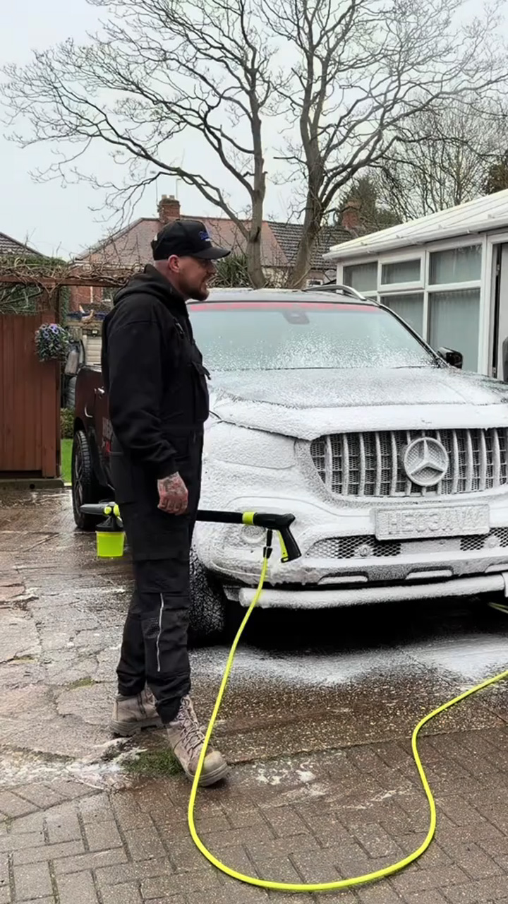 Power washing a dirty Mercedes SUV back to a shine