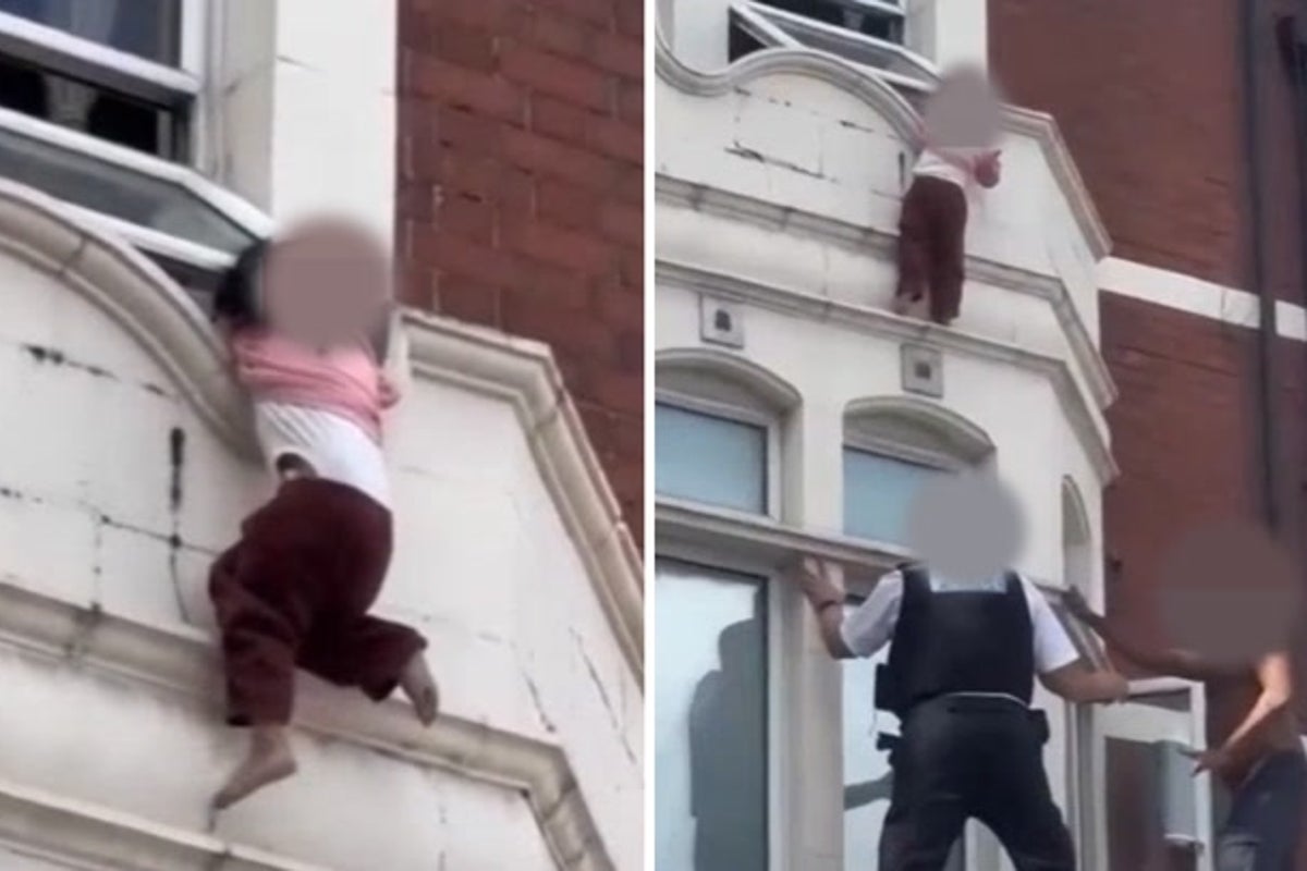 Child dangling from rooftop window rescued by police and bystanders