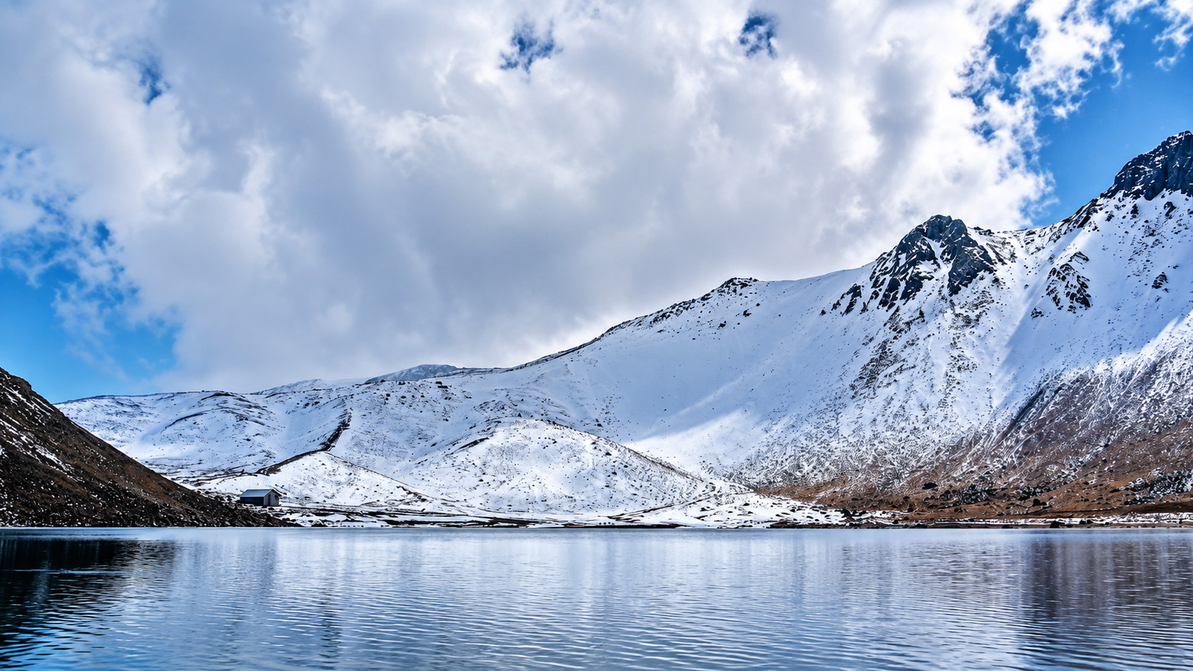 An alpine lake beneath Colombia’s snow-capped Los Nevados peaks