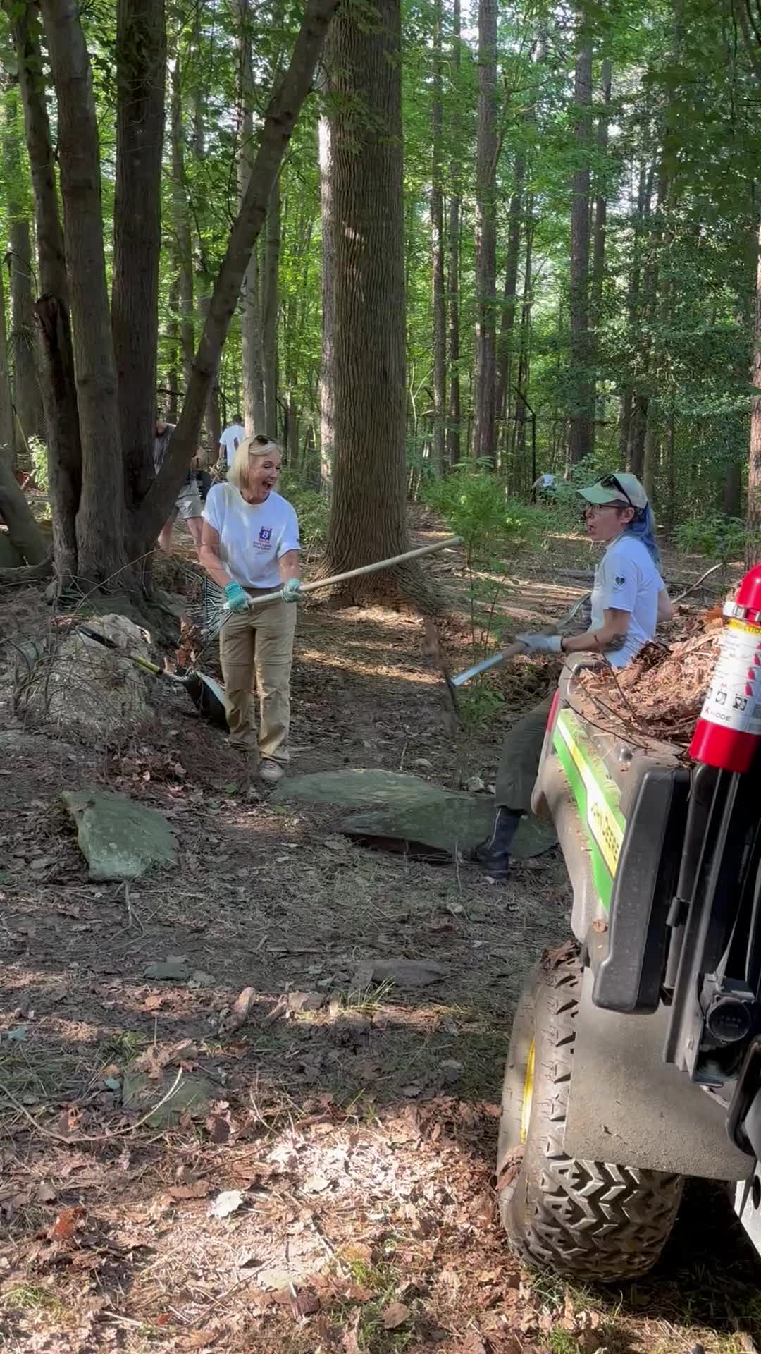 Volunteers work in the bear den habitat at the NC Zoo