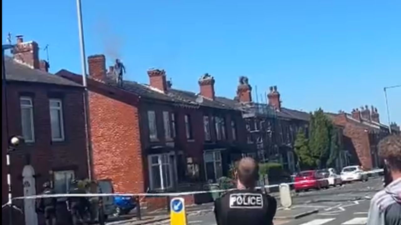 Tense standoff as man on roof hurls debris at officers