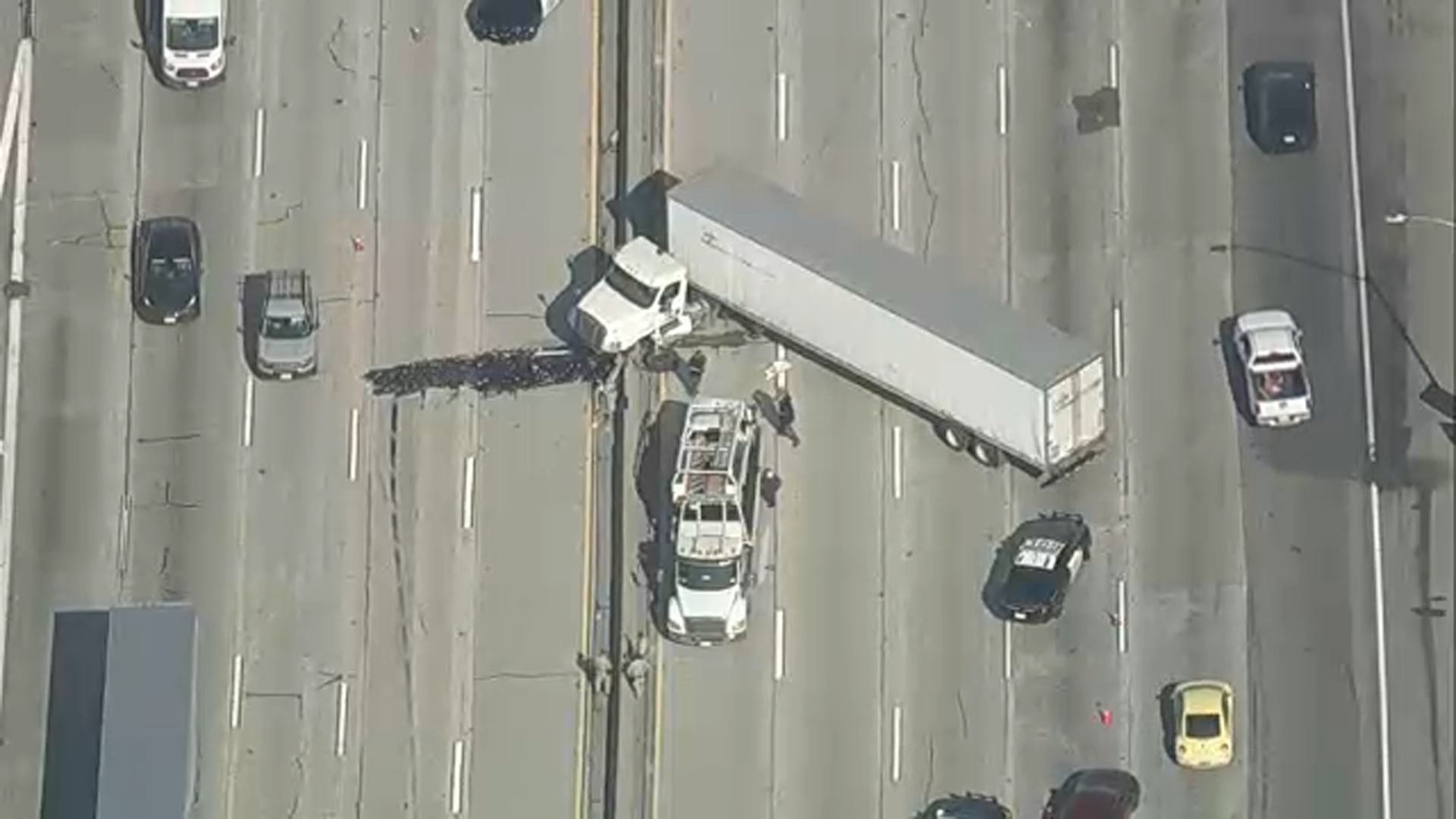 Jackknifed big rig blocks lanes on both sides of 210 Freeway in Azusa