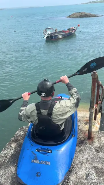 Kayak stair launch into the sea on a bright coastal day