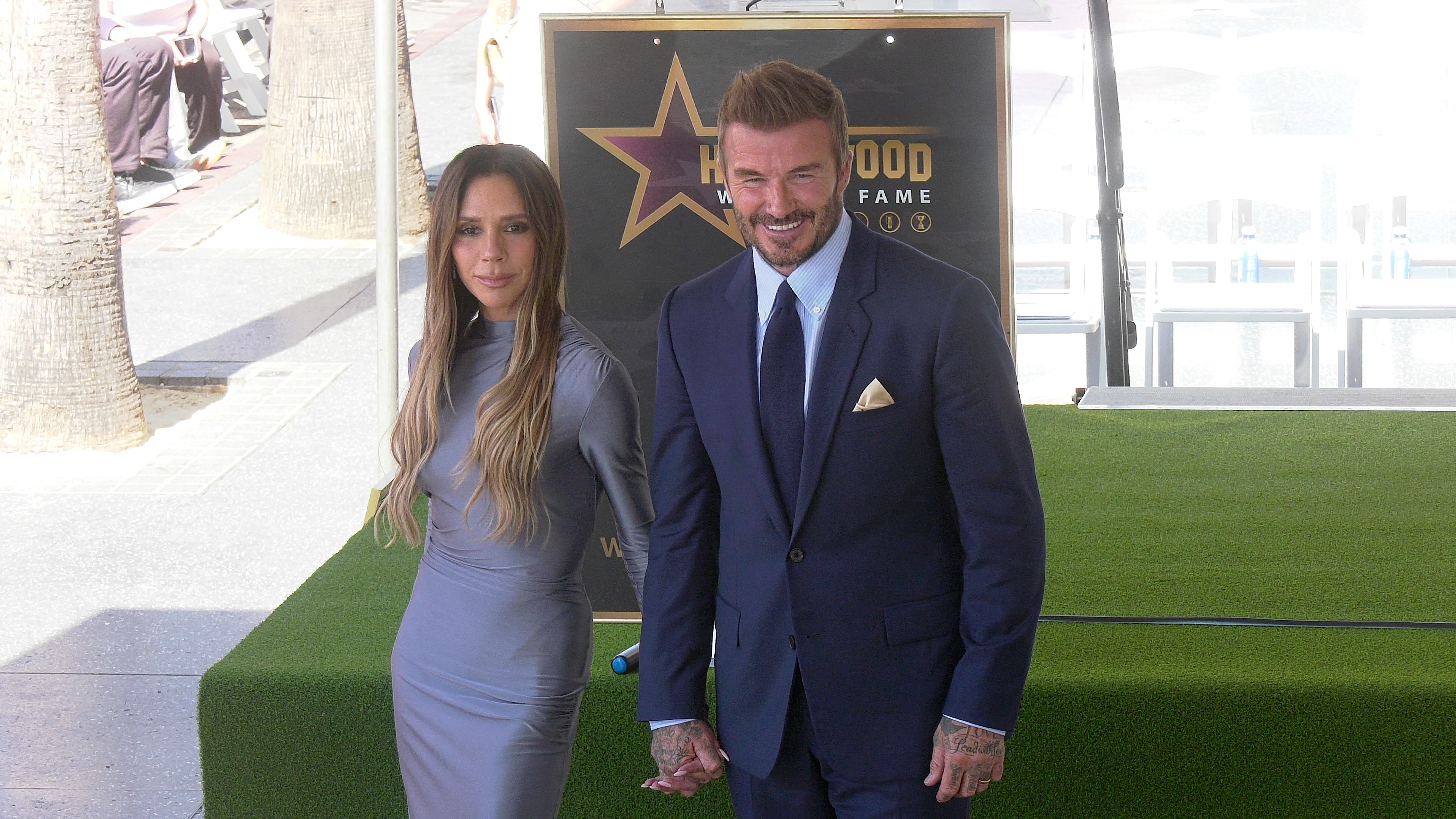 David Beckham poses with Victoria Beckham next to his star on the ...