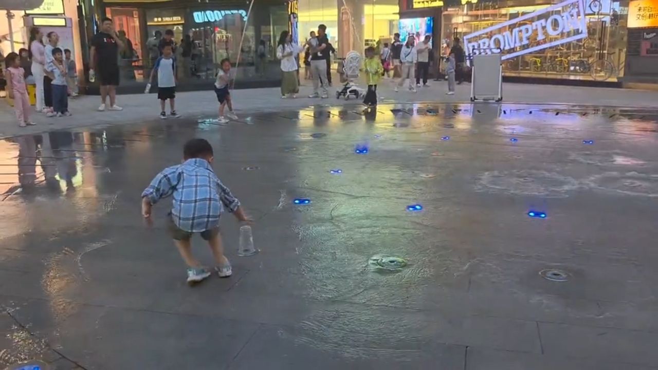 Kids watch cups soar in magical fountain show