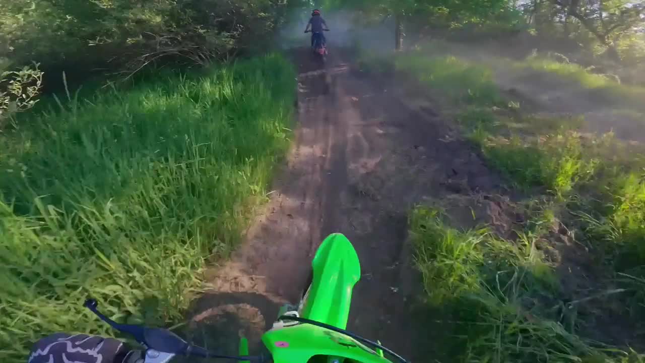 Motorbike slips on muddy slope during uphill ride in Baldwin, Michigan, USA