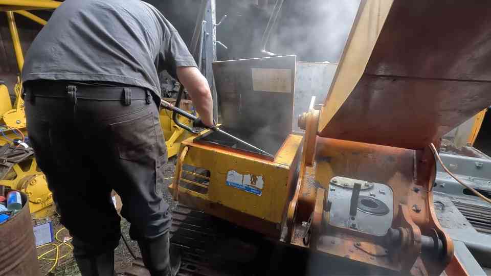 Excavator frame painting prep in non-ideal conditions