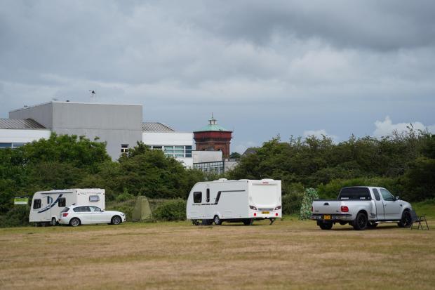College 'glad' travellers move on peacefully from 'precious' land
