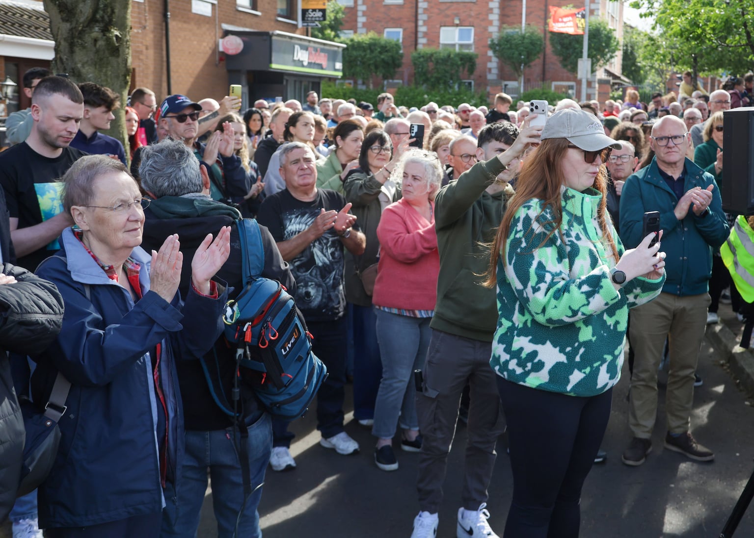 Anti-racism rally in west Belfast hears community must stand together ...