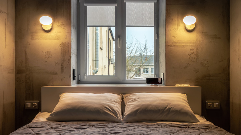 Balance the look of your bed up against the wall with a simple window ...
