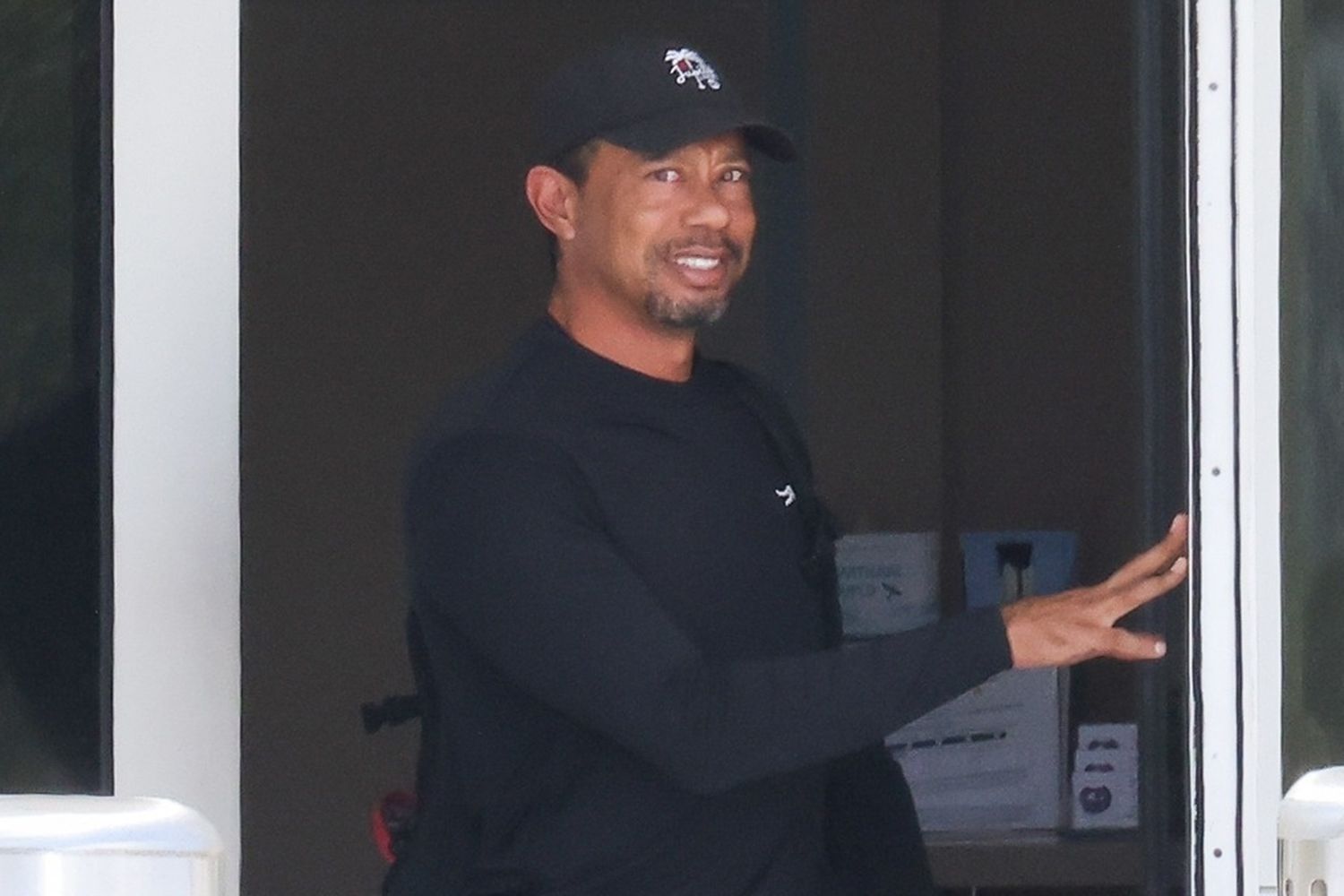 Tiger Woods grins as he's spotted returning home from rehab stint overseas
