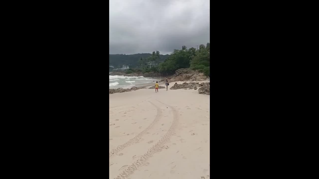 Female British tourist sparks chaos on beach by snatching red flag and ...
