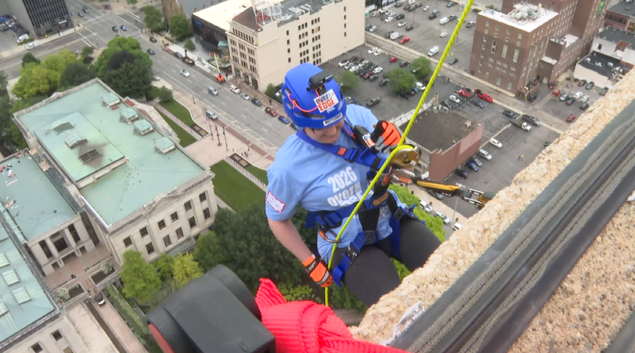 Fundraisers rappel down skyscraper to end child exploitation