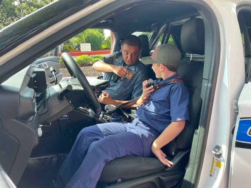 Secaucus police officer shows Cub Scouts inside police car