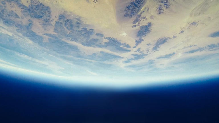 Earth’s atmosphere has no sharp edge; it simply fades into space