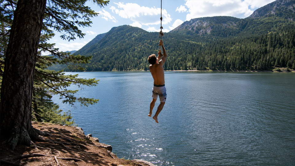 High flying rope swing ends in epic lake landing