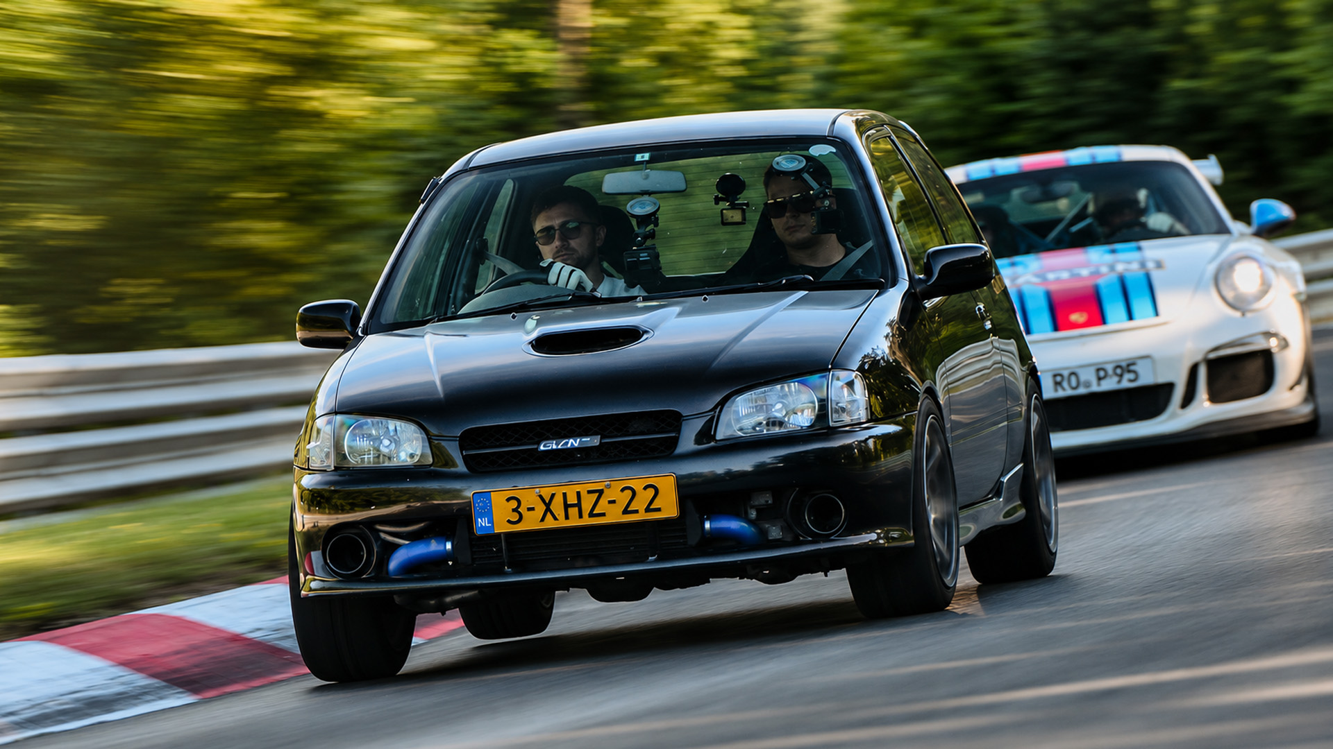 Small Toyota Starlet challenges Porsche GT3RS on race track