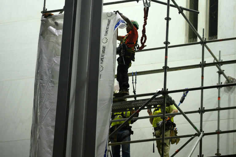 A tarp now covers where Trump's name used to hang at the Kennedy Center