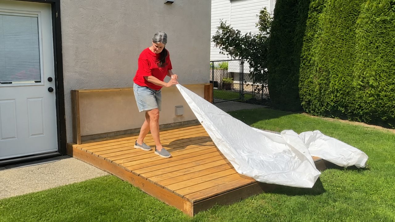 She lays a tarp over her deck for this brilliant summer backyard idea!